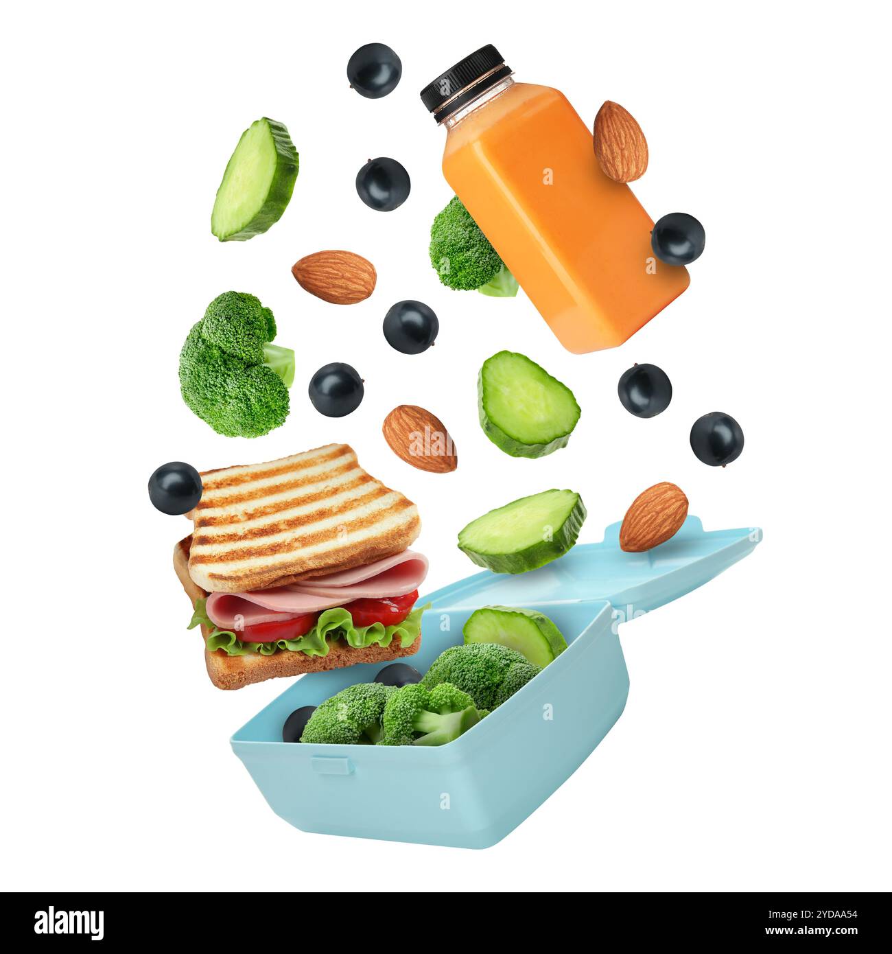 Lunch box, different food and bottle of juice in air on white ...