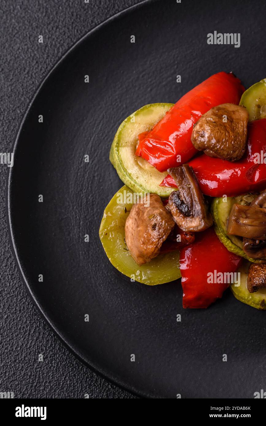 Delicious fresh grilled vegetables zucchini, bell peppers, mushrooms and onions baked on the ...