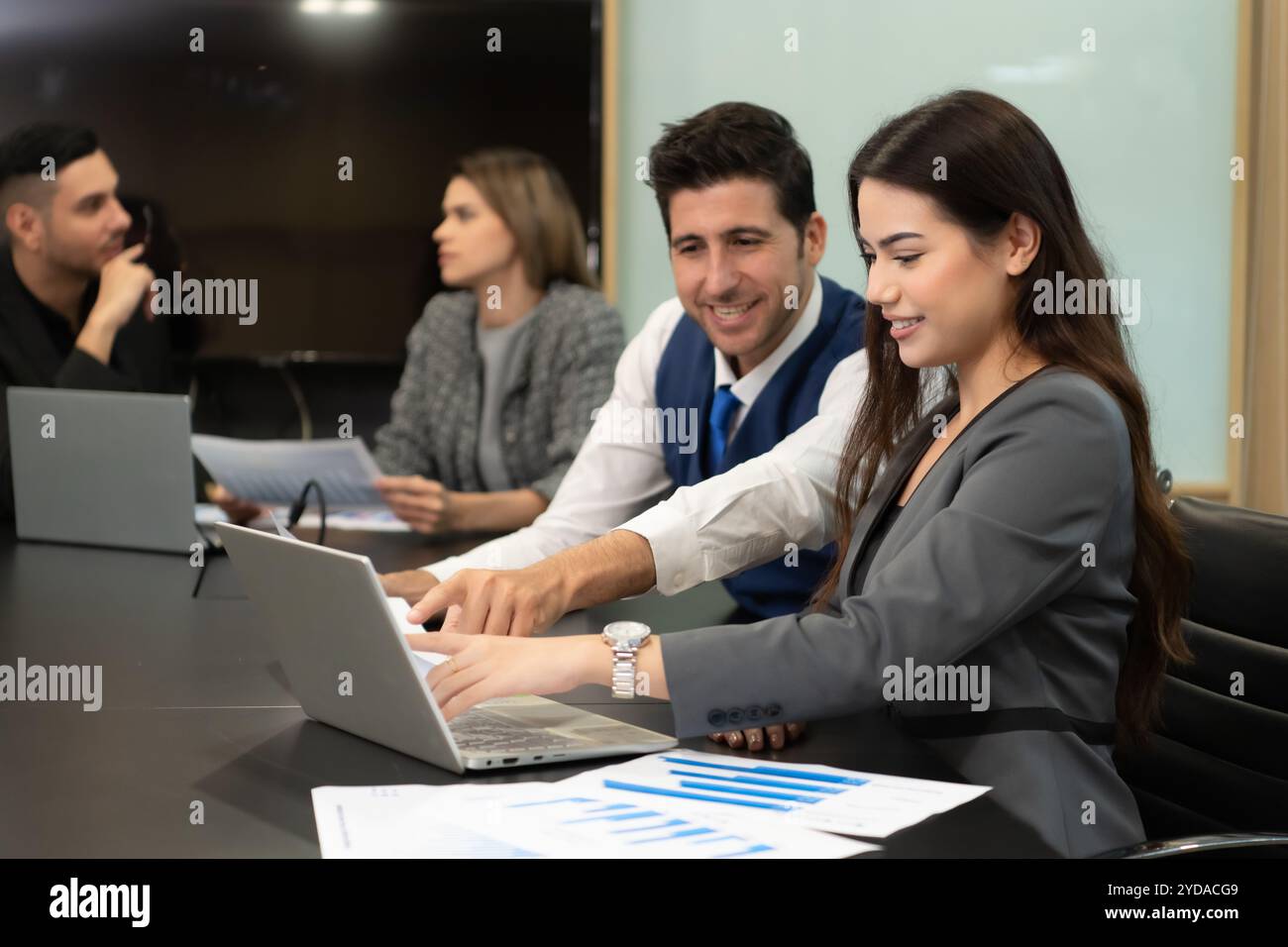 New business people in the conference room are exchanging information ...