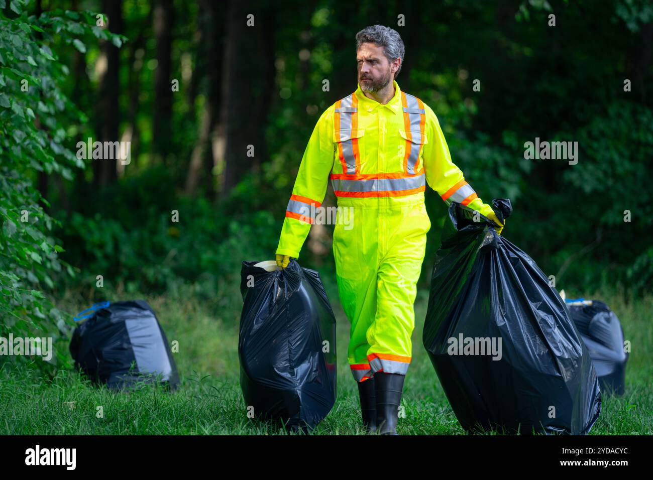Volunteer man picking plastic trash for cleaning the nature. Clean up ...