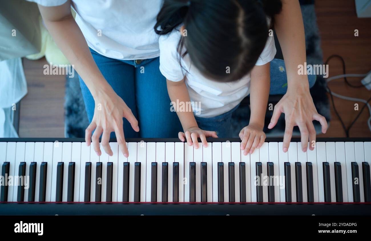 Family vacation, other helping daughter practice in her piano lessons Stock Photo - Alamy