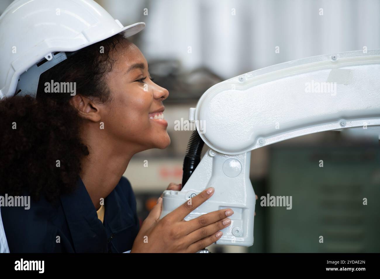 Portrait of a young female engineer in the welding robot industry ...