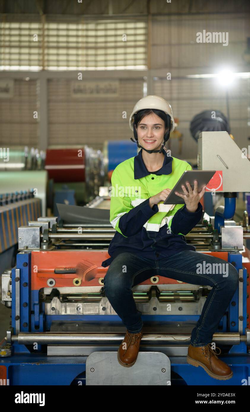 Portrait of a heavy equipment female engineer from a huge industry ...