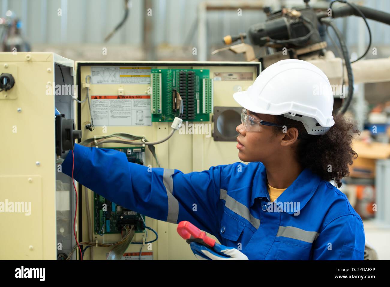 Experienced female electrical engineer The electrical system of the ...