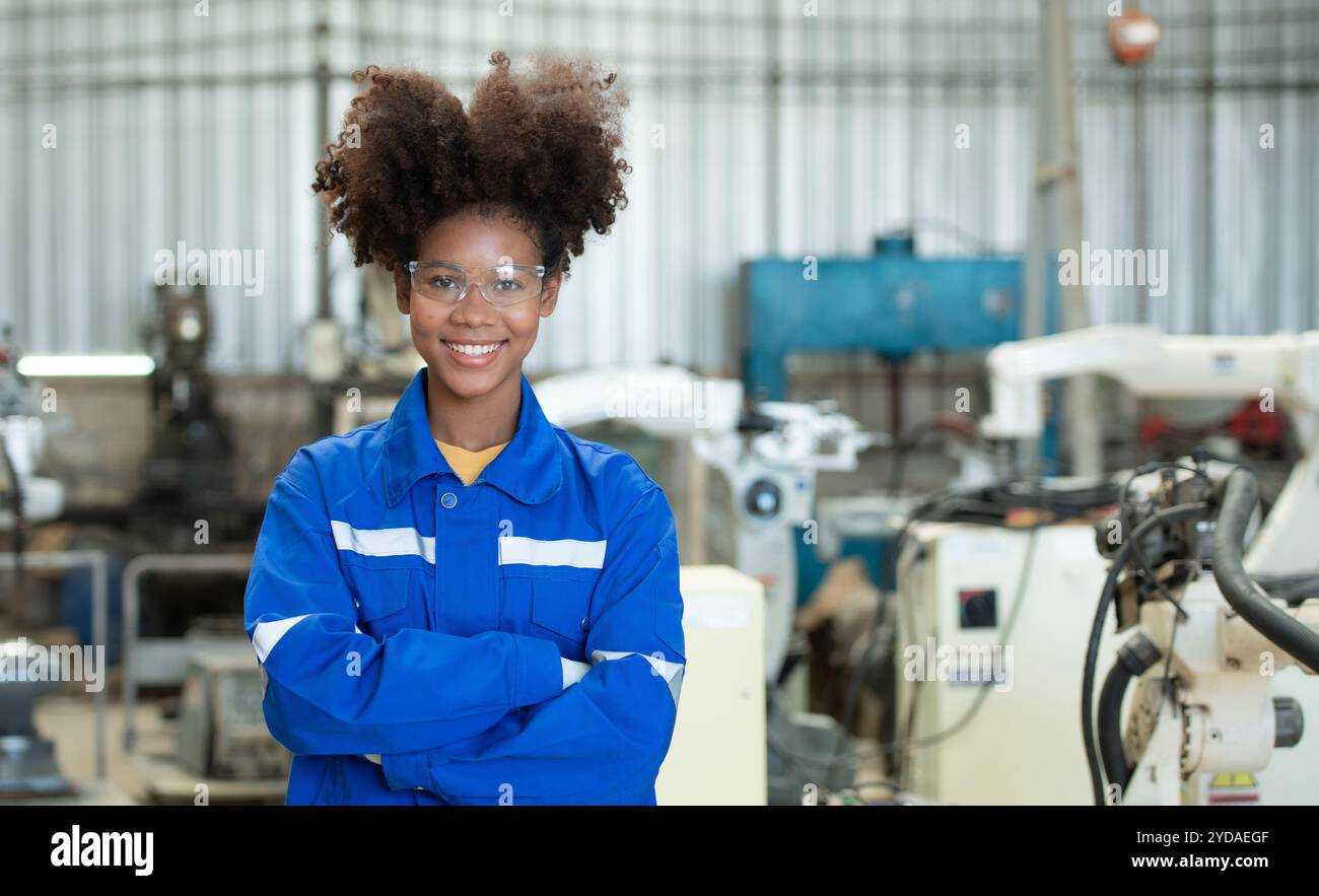 Young female engineers are manipulating a welding robot hand. By ...