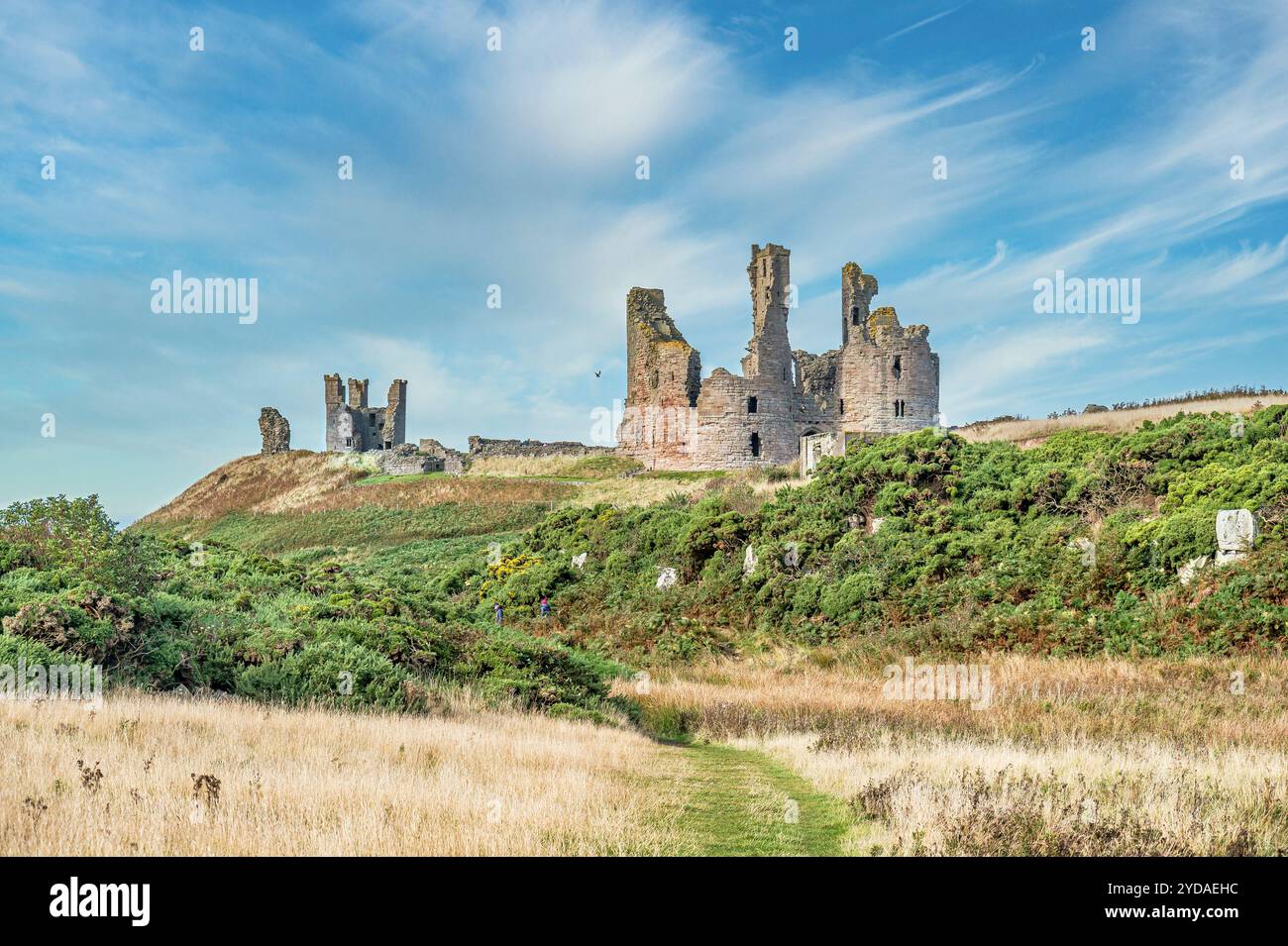 The image is of the medieval castle of Dunstanburgh castle that ...