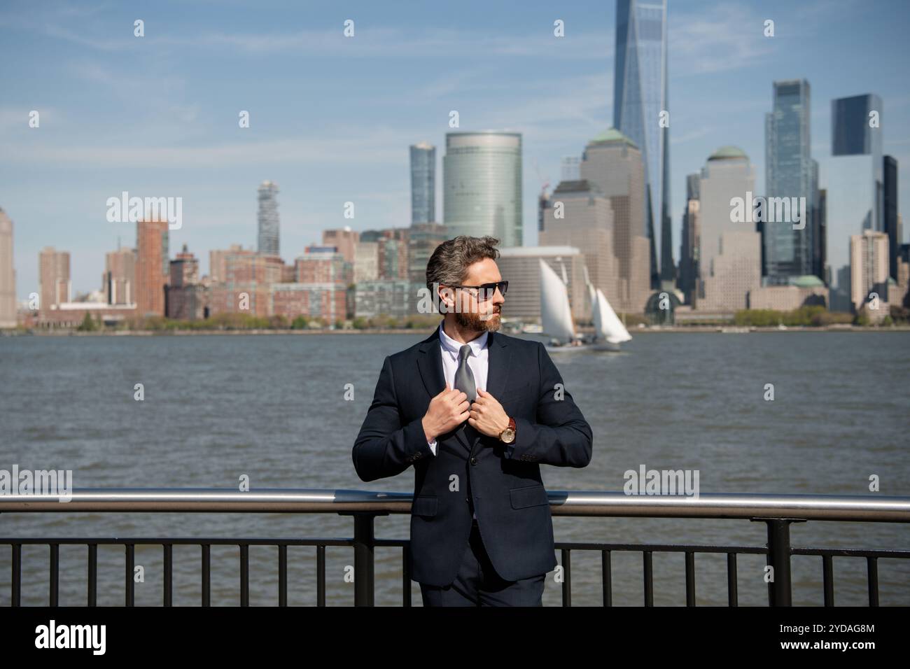 Confident rich business man executive standing in New York City ...