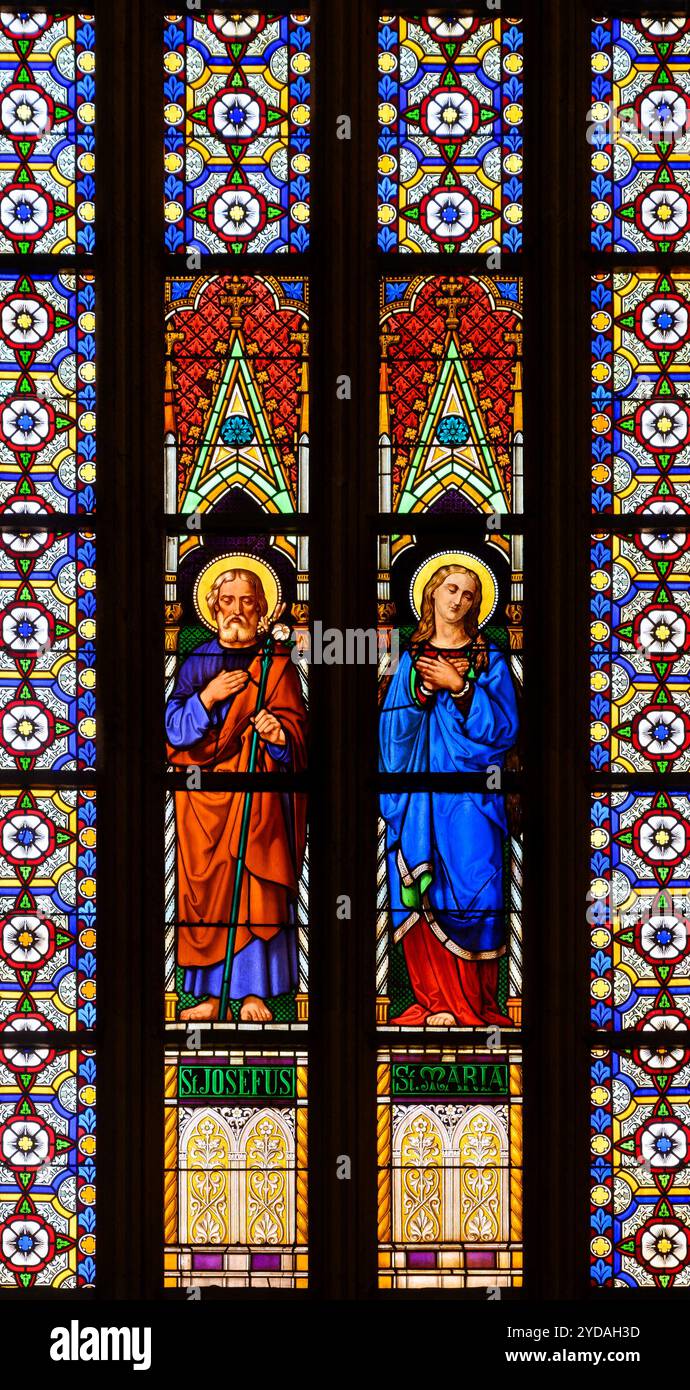 The Blessed Virgin Mary and St Joseph. Stained-glass window in the St ...