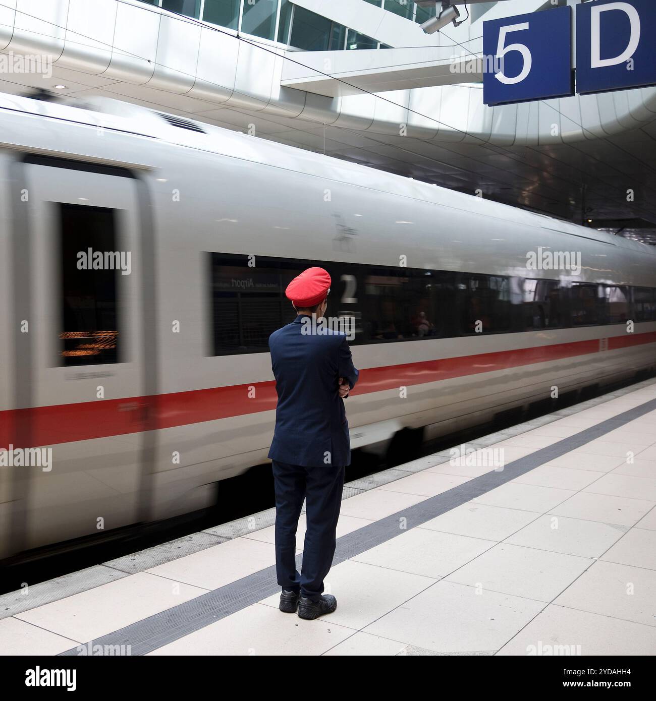 ICE in motion with Deutsche Bahn employee, long-distance train station ...