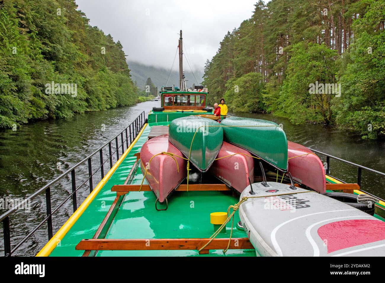 A barge heading through the section of the Caledonian Canal known as ...