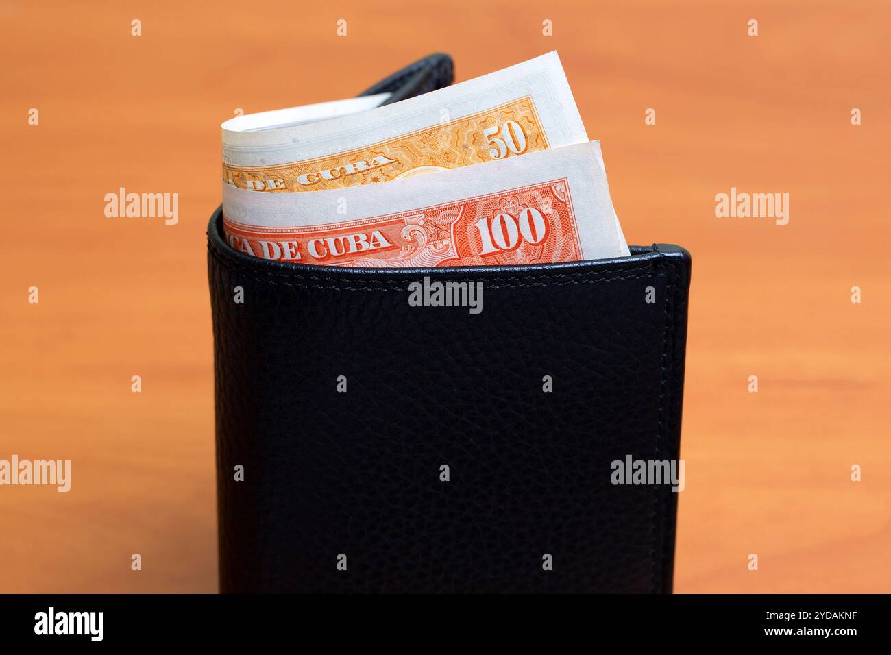 Old Cuban Pesos in the black wallet Stock Photo - Alamy