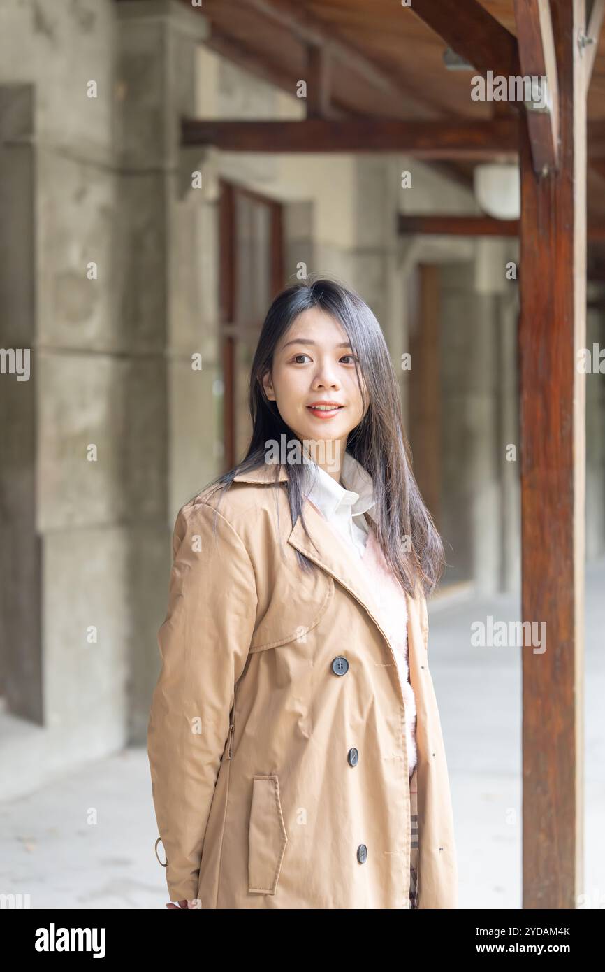 A long-haired Taiwanese woman in her 20s wearing a beige trench coat ...