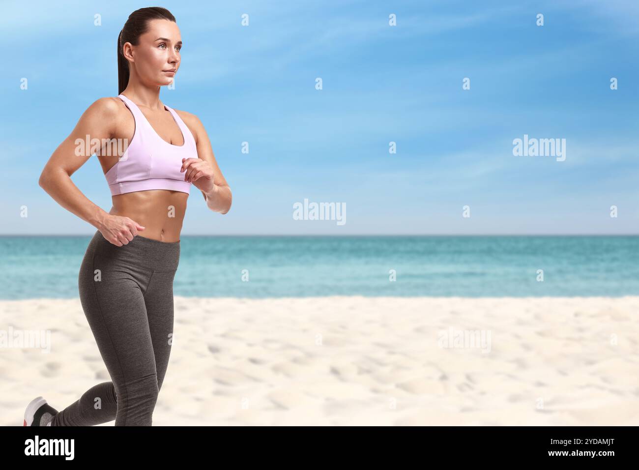Beautiful woman running on beach. Space for text Stock Photo - Alamy