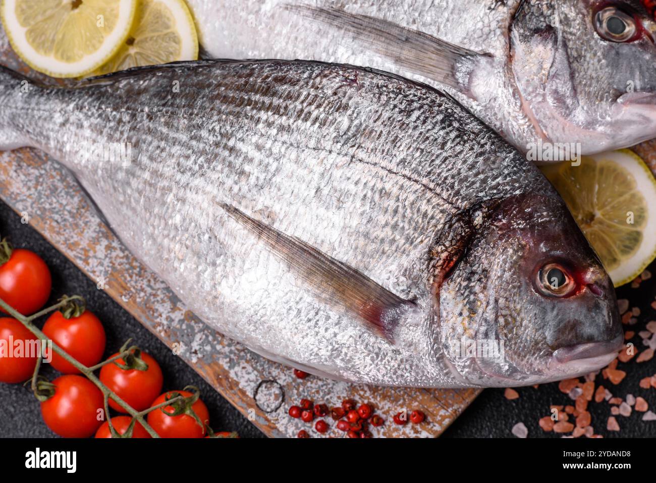 Whole raw dorado fish with lemon, salt, spices and herbs Stock Photo ...