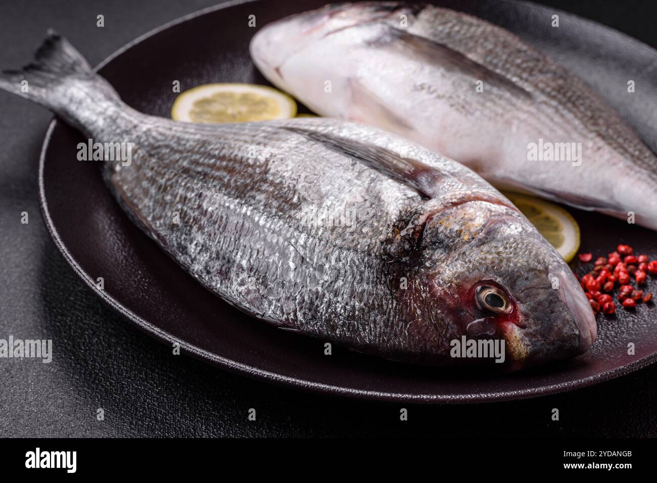 Whole raw dorado fish with lemon, salt, spices and herbs Stock Photo ...