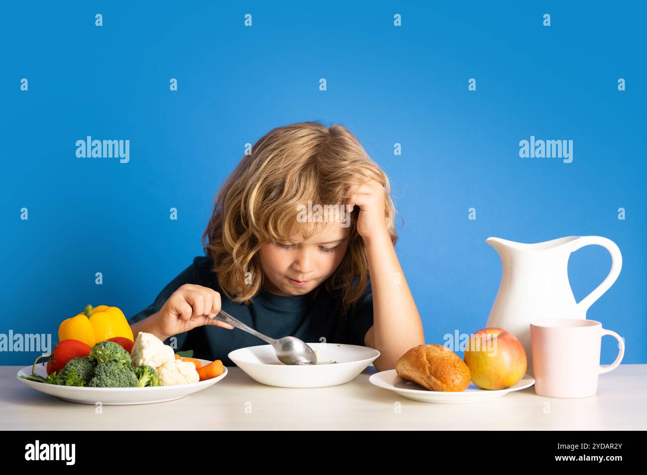 Tired kid boy have a dinner. Bad appetite. Child eating soup. Young boy ...