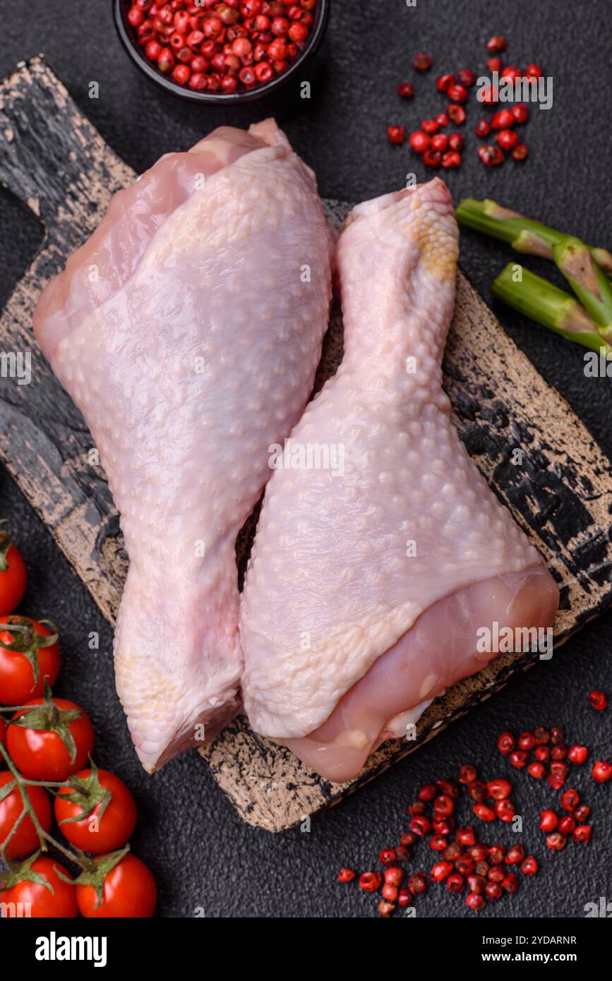 Raw chicken legs with salt, spices and herbs Stock Photo - Alamy