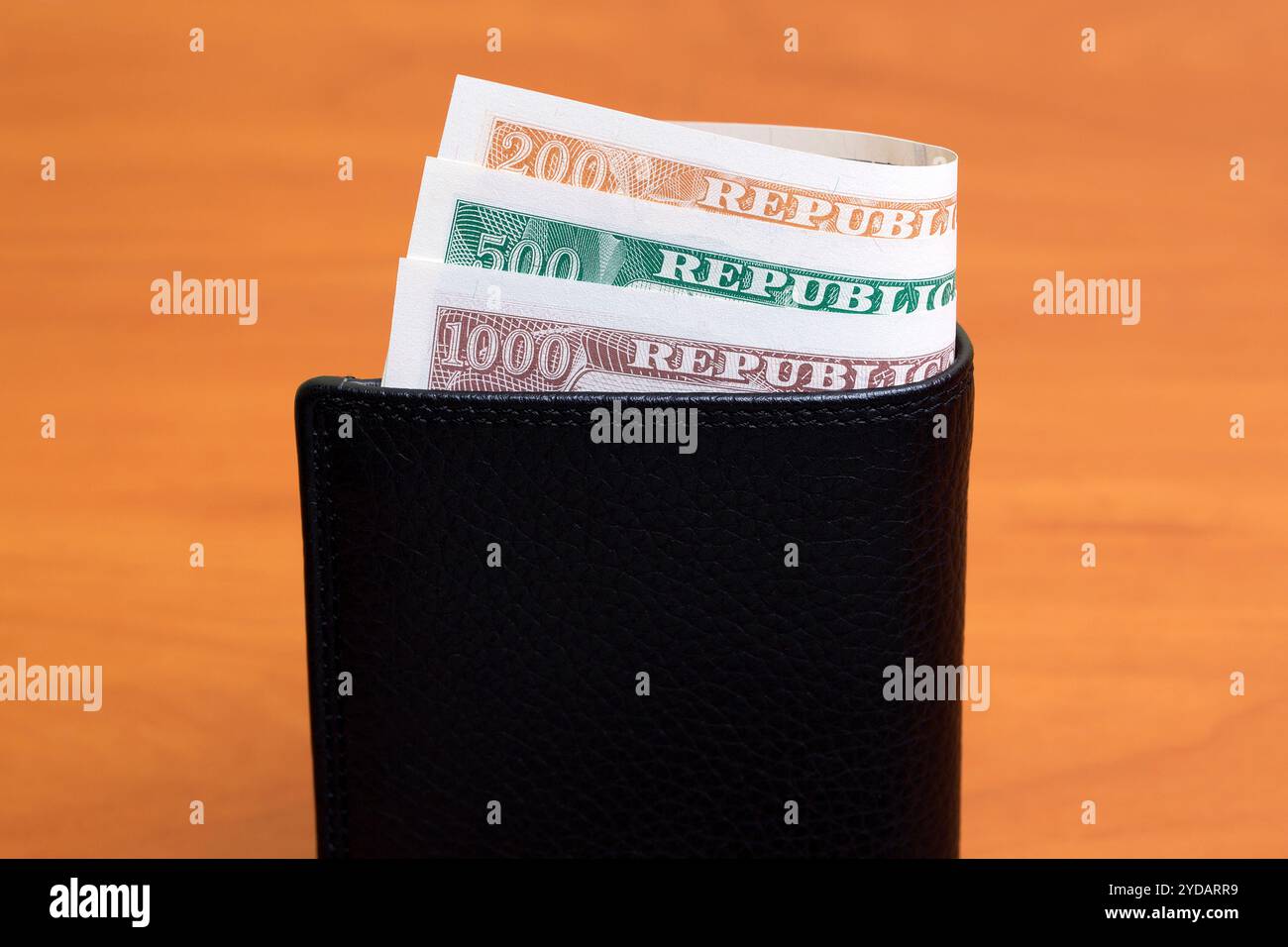 Cuban Peso in the black wallet Stock Photo - Alamy
