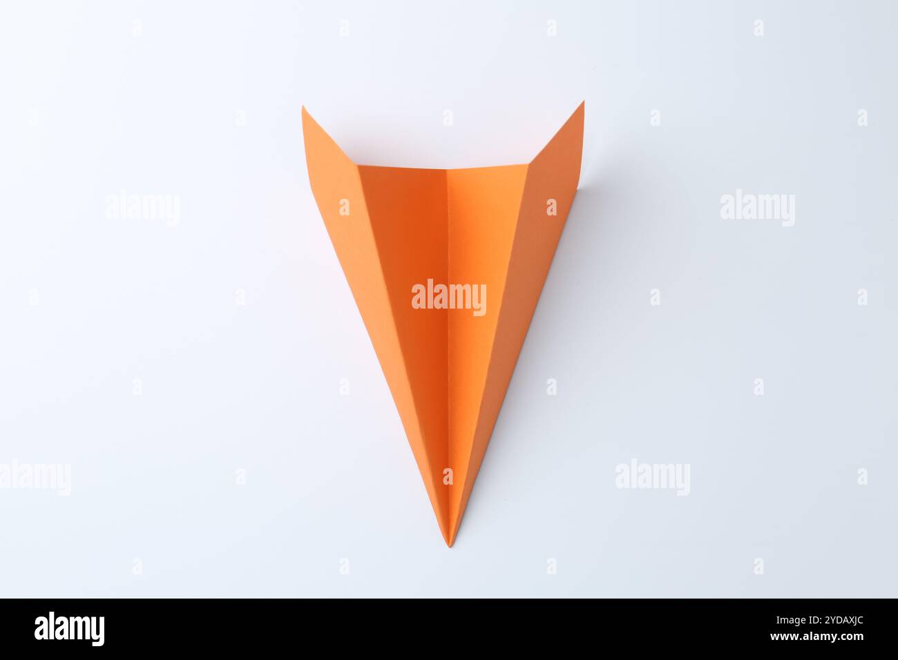 One handmade orange paper plane on white background, top view Stock ...