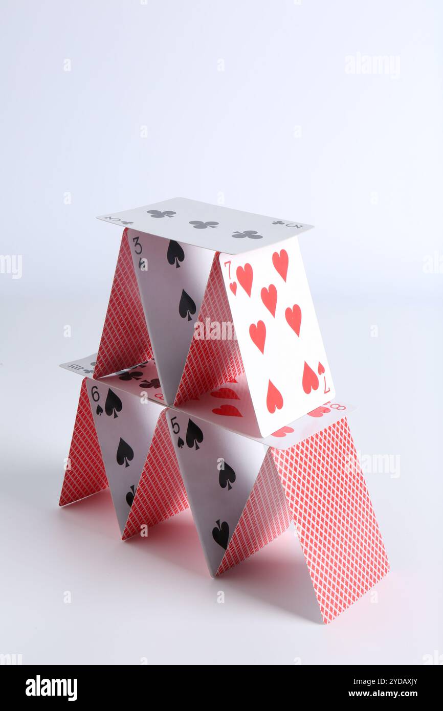 House of playing cards on white background Stock Photo - Alamy