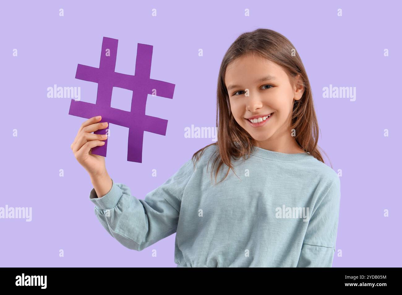 Cute teenage girl with hashtag on lilac background Stock Photo - Alamy