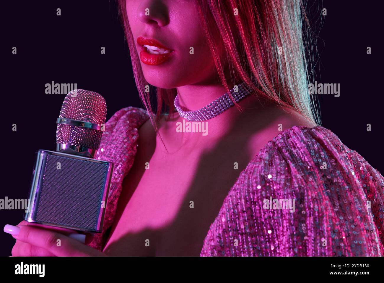 Beautiful female singer with microphone on dark background Stock Photo ...