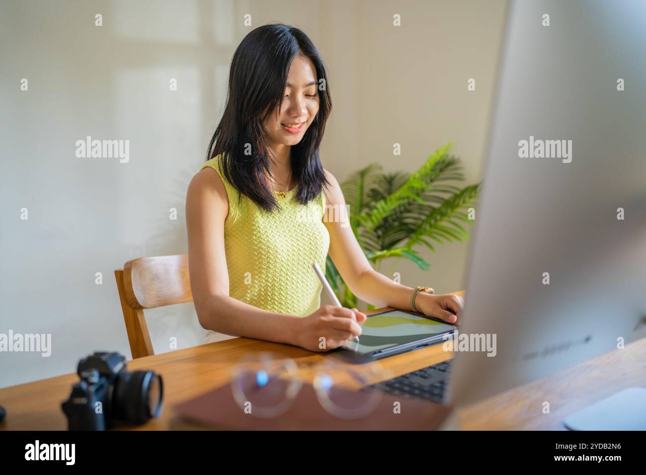 Graphic designer working on digital tablet and computer. Designer Asian ...