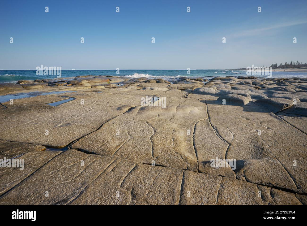 Rock platform and rocky ledges jutting out into the ocean at Point ...