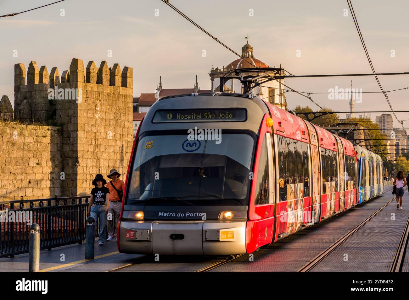 The Metro light rail line on the The Dom Luís I Bridge and the Walls of ...