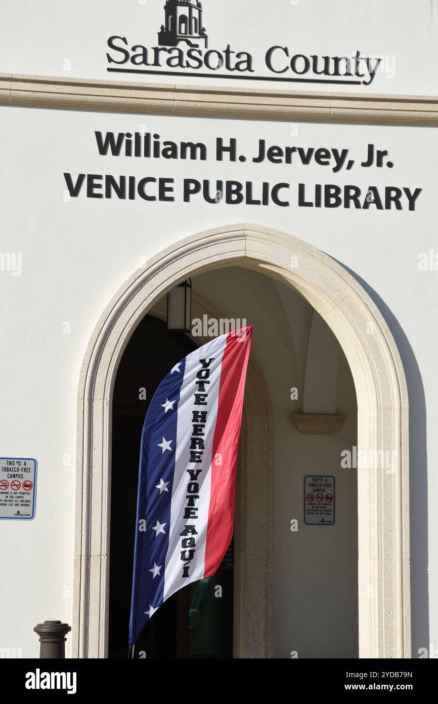 Venice, Florida, USA – Oct 24, 2024: 'Vote here' flag in both English ...