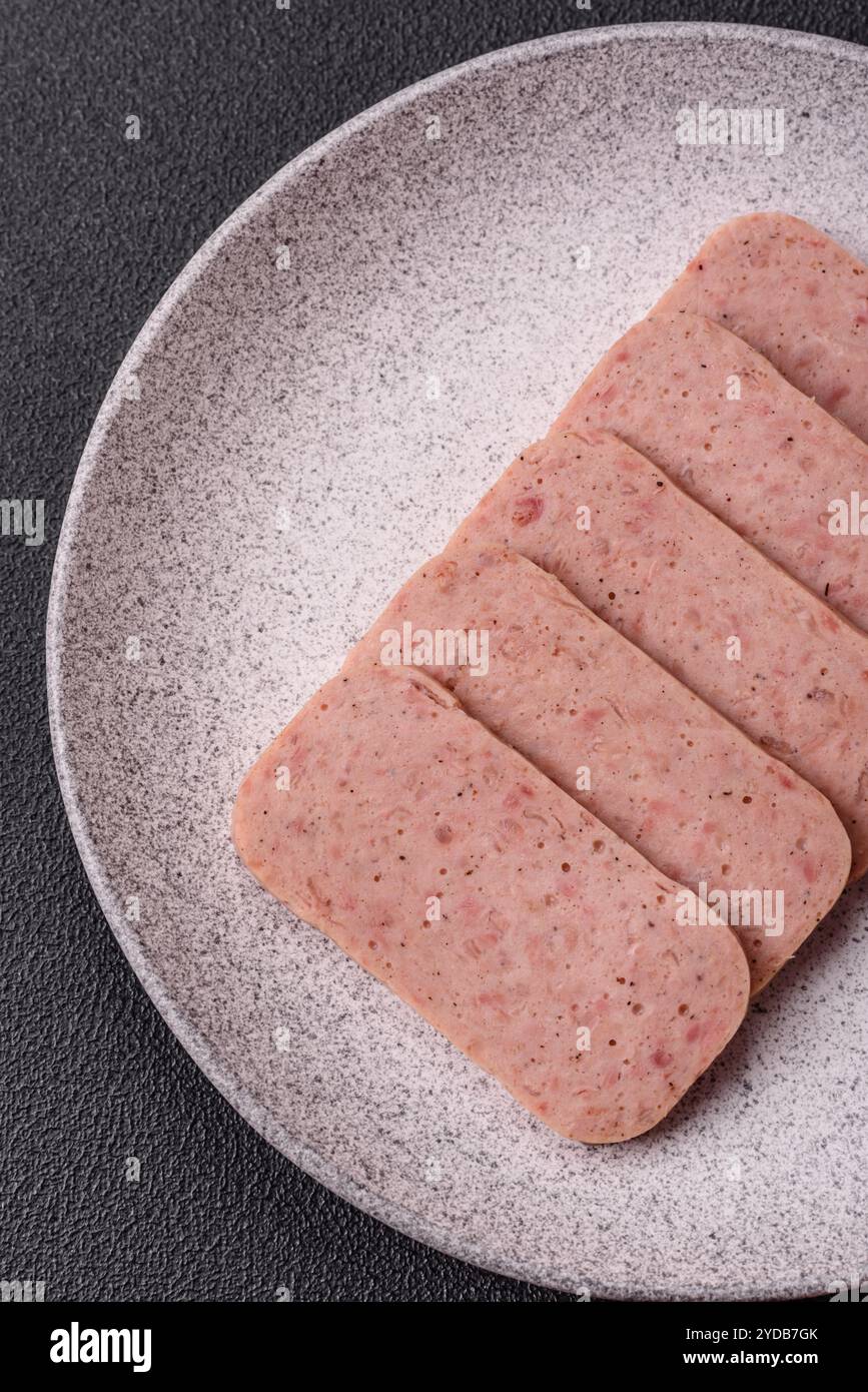 Delicious canned pink ham with salt, spices and herbs on a dark ...