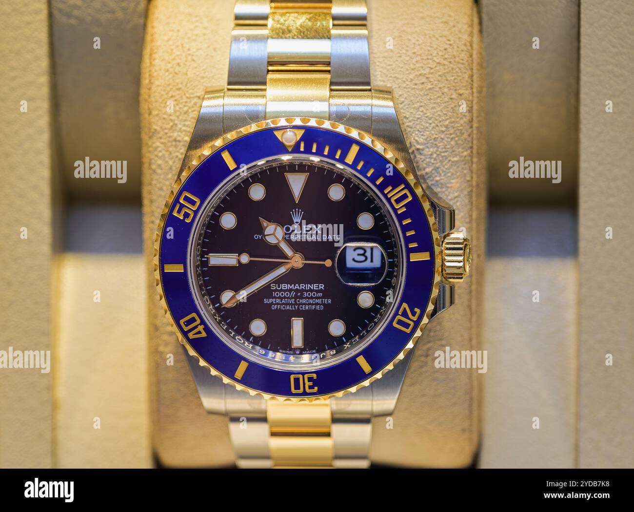 A striking Rolex watch showcases a blend of blue, black, gold, and ...