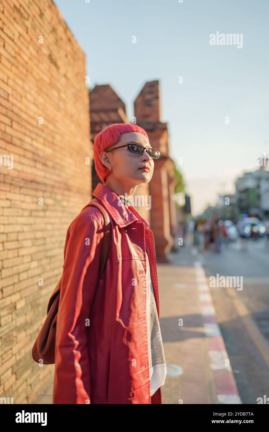 Gen z girl leather fashion with punk Asian woman tourist of local city ...