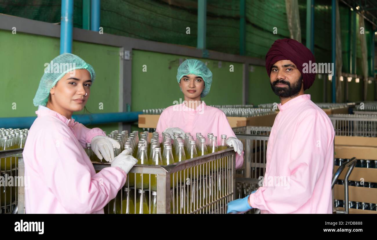 Product quality control staff at the fruit juice production line ...