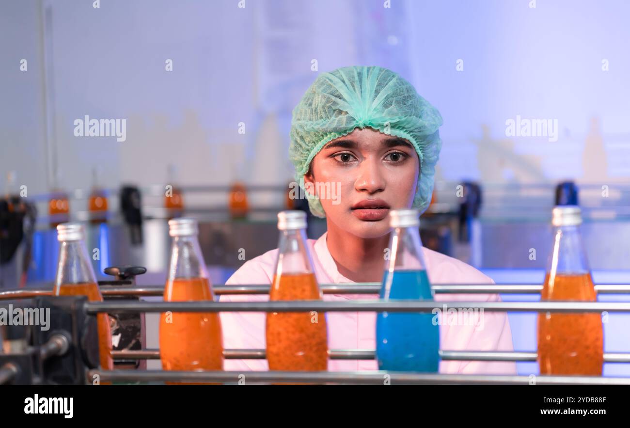 Product quality control staff at the fruit juice production line ...