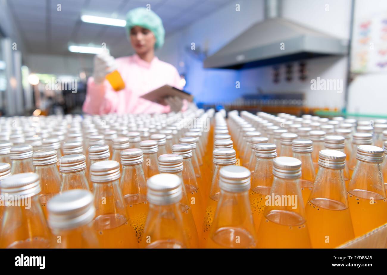 Product quality control staff at the fruit juice production line ...