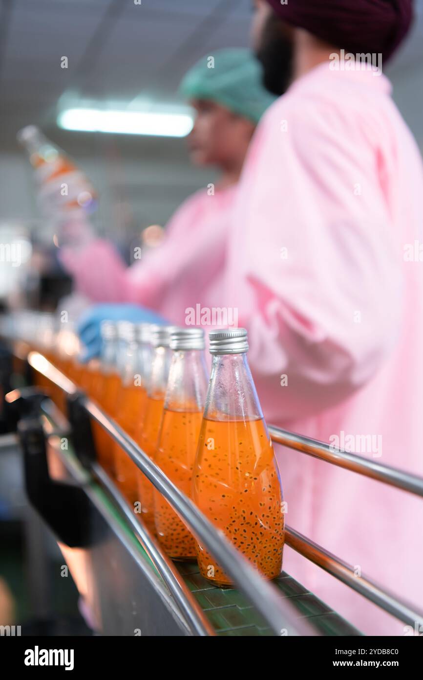 Product quality control staff at the fruit juice production line ...