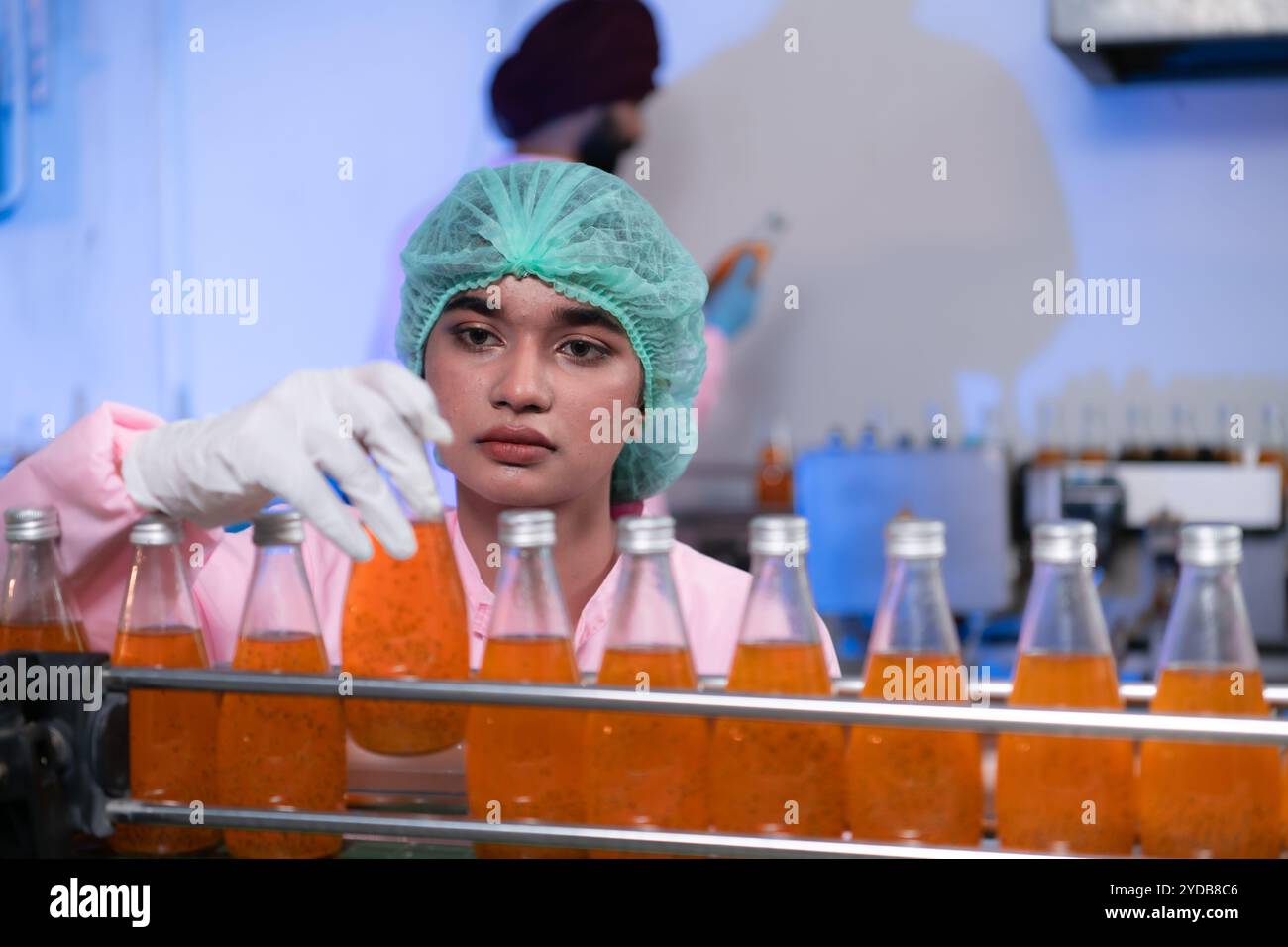 Product quality control staff at the fruit juice production line ...