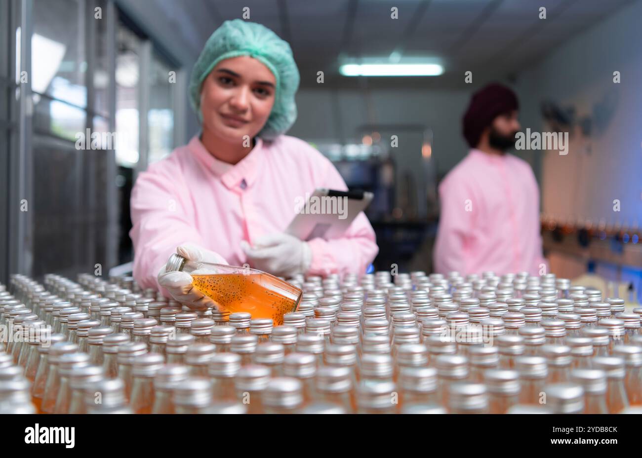 Product quality control staff at the fruit juice production line ...