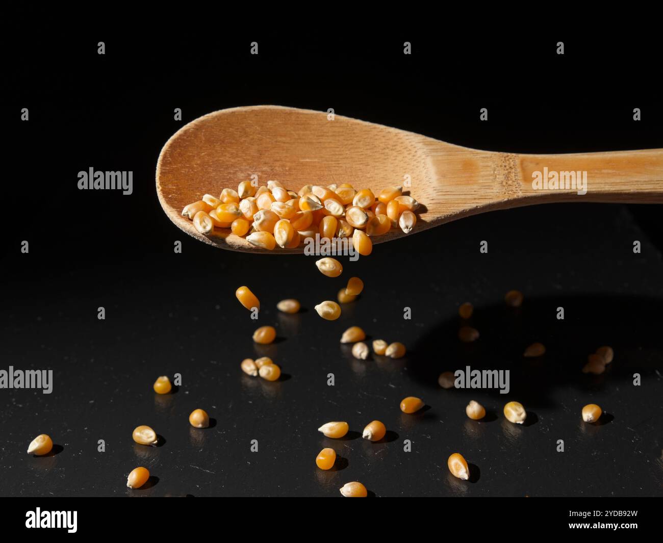Popcorn kernels falling off spoon Stock Photo - Alamy
