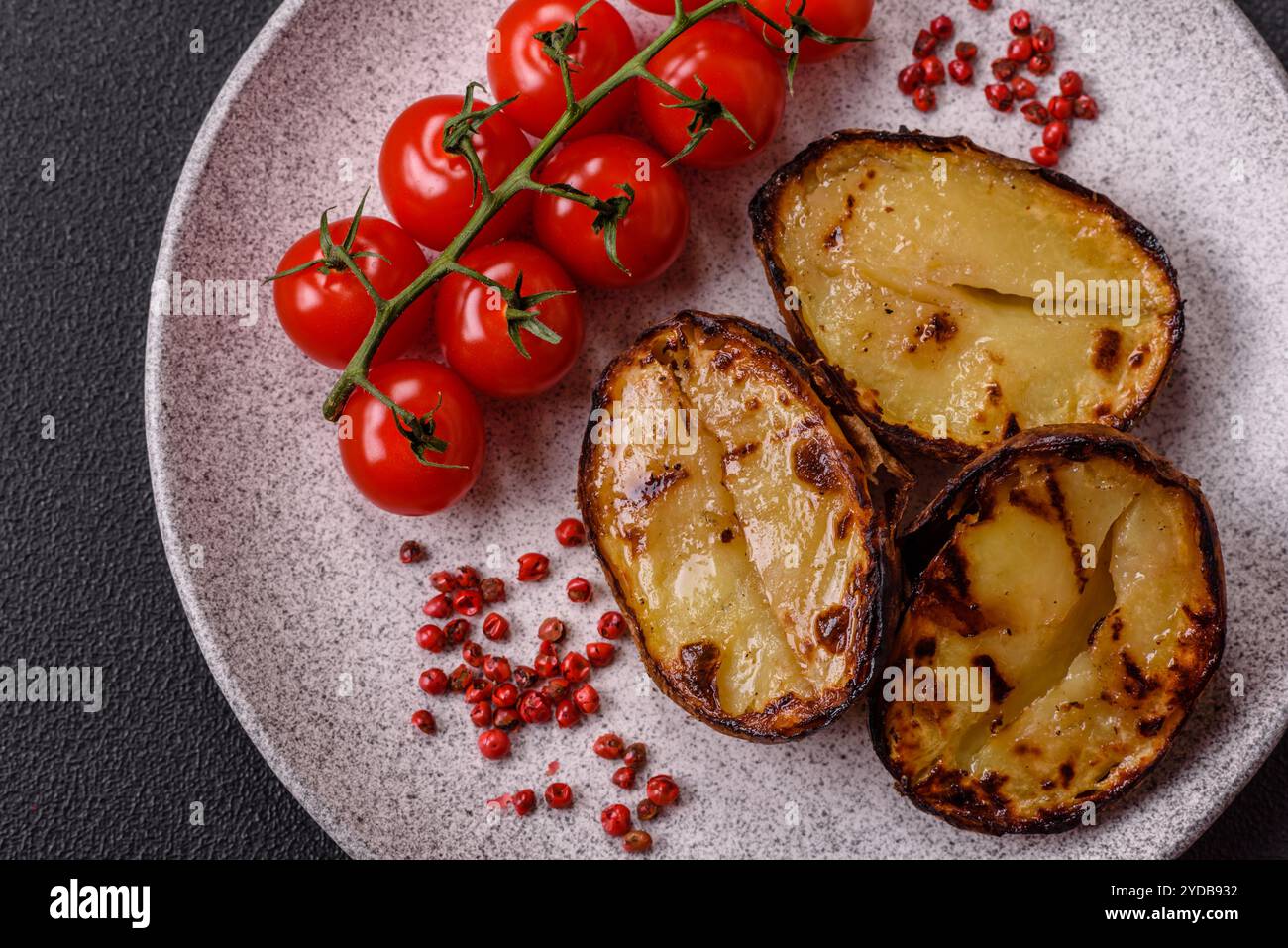 Delicious potato halves in skins baked on the grill Stock Photo - Alamy