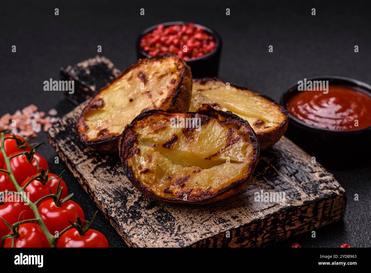 Delicious potato halves in skins baked on the grill Stock Photo - Alamy