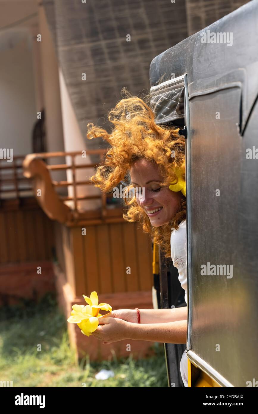 girl on a tourist trip enjoys the ride in an authentic Indian rickshaw ...