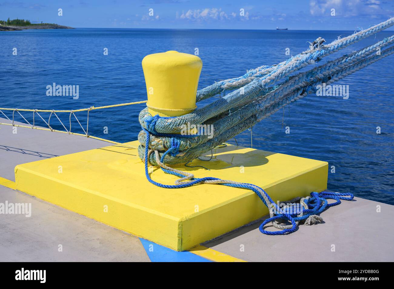Secure Mooring. Thick cruise ship ropes fastened tightly to a bollard ...