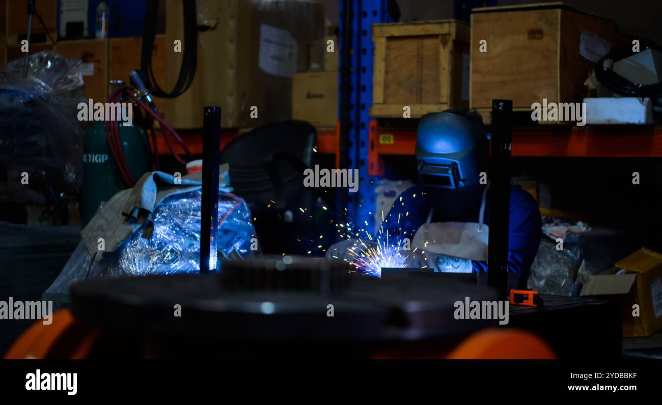 A welder is working to weld metal. to create quality work according to ...
