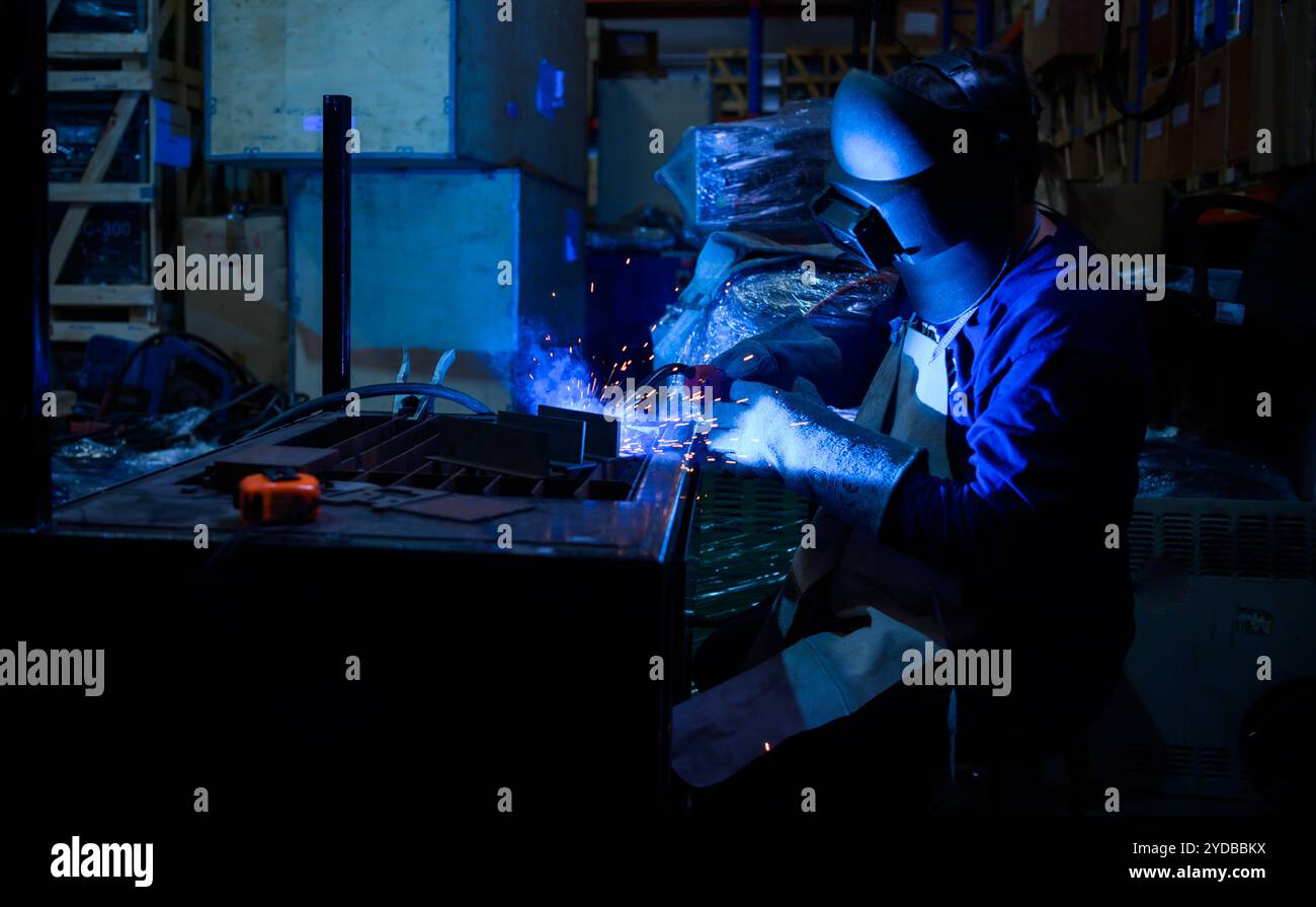 A welder is working to weld metal. to create quality work according to ...
