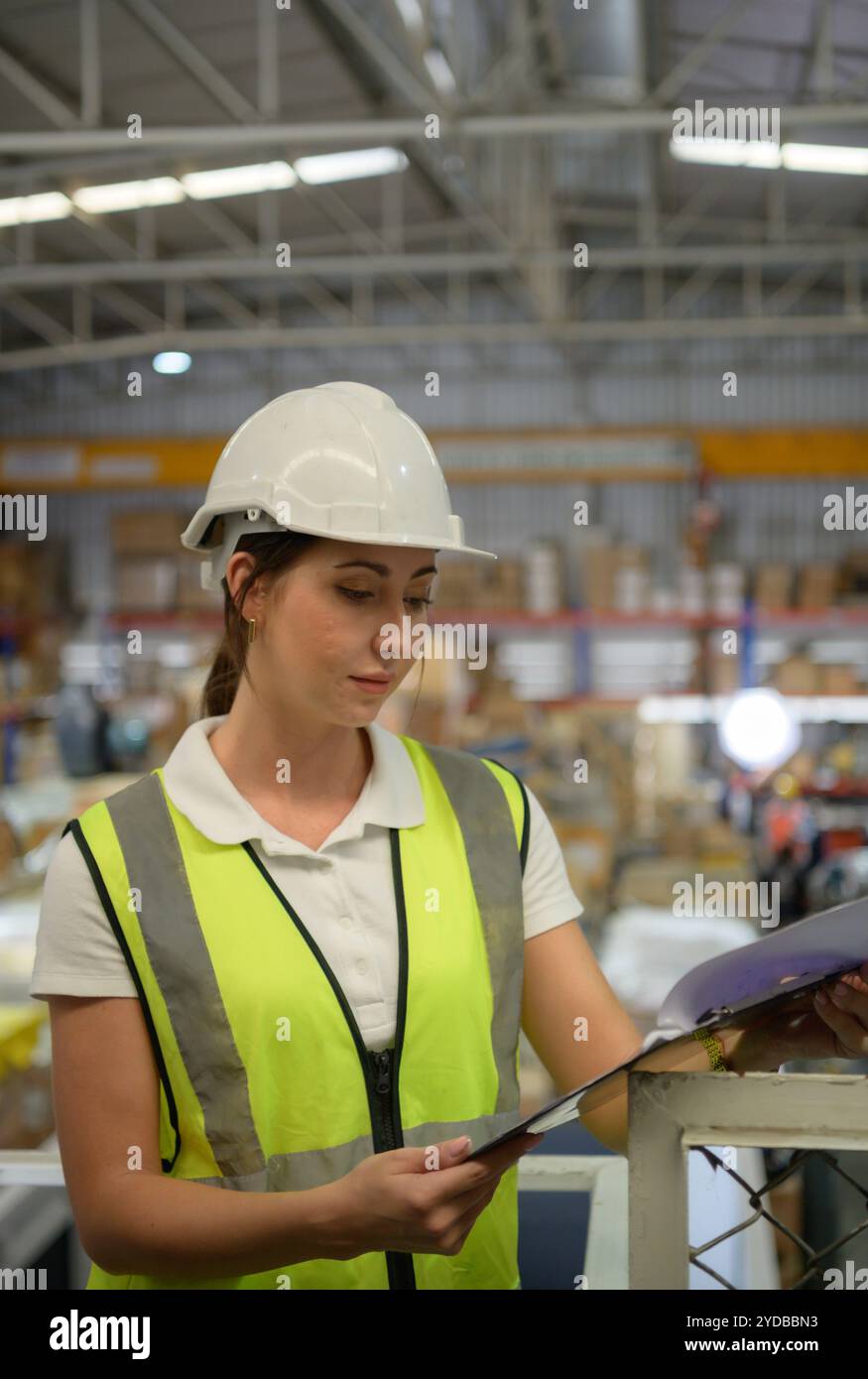 Female warehouse worker Counting items in an industrial warehouse on ...