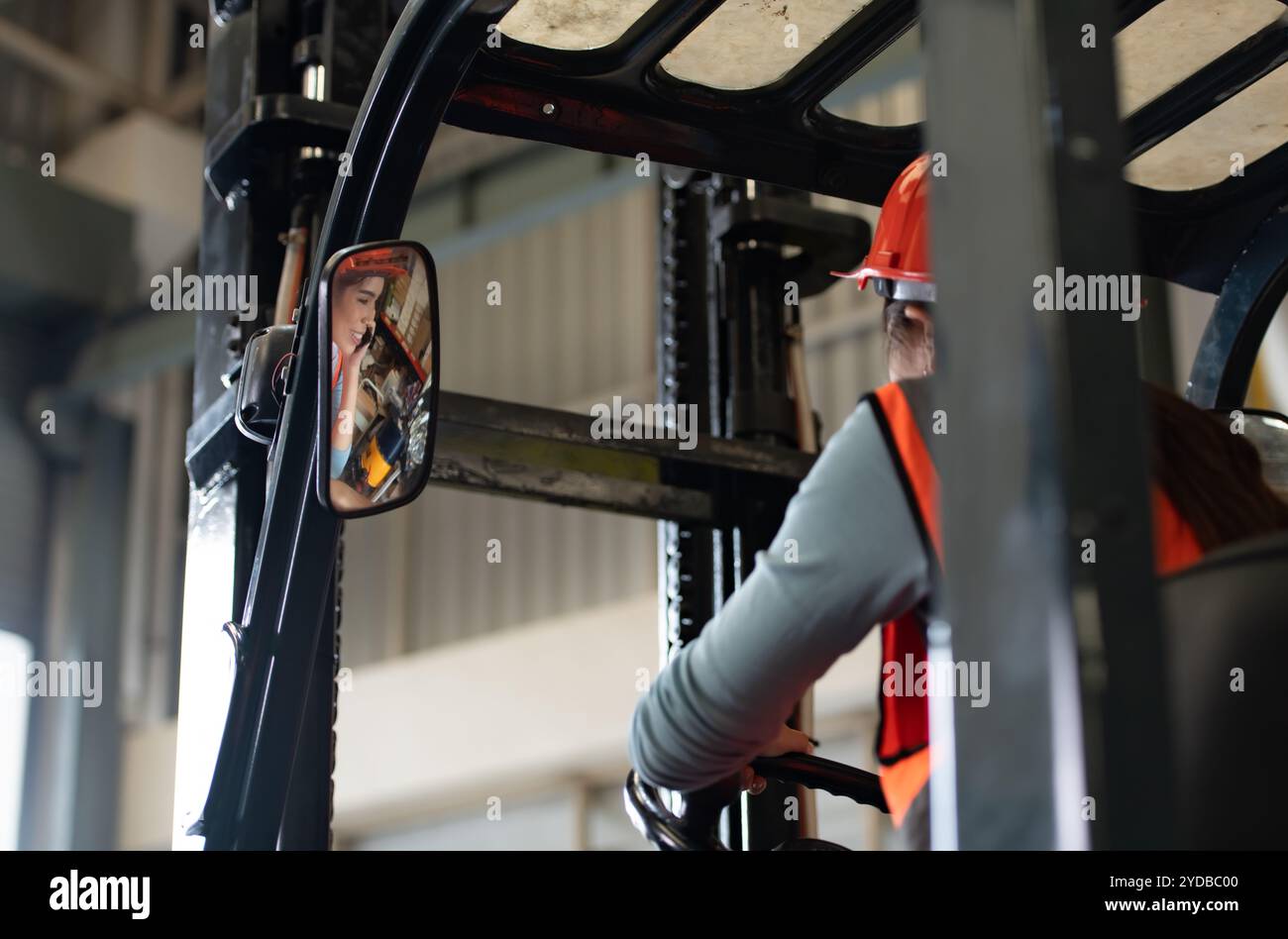 Portrait of an Asian woman with a forklift used to lift heavy objects ...
