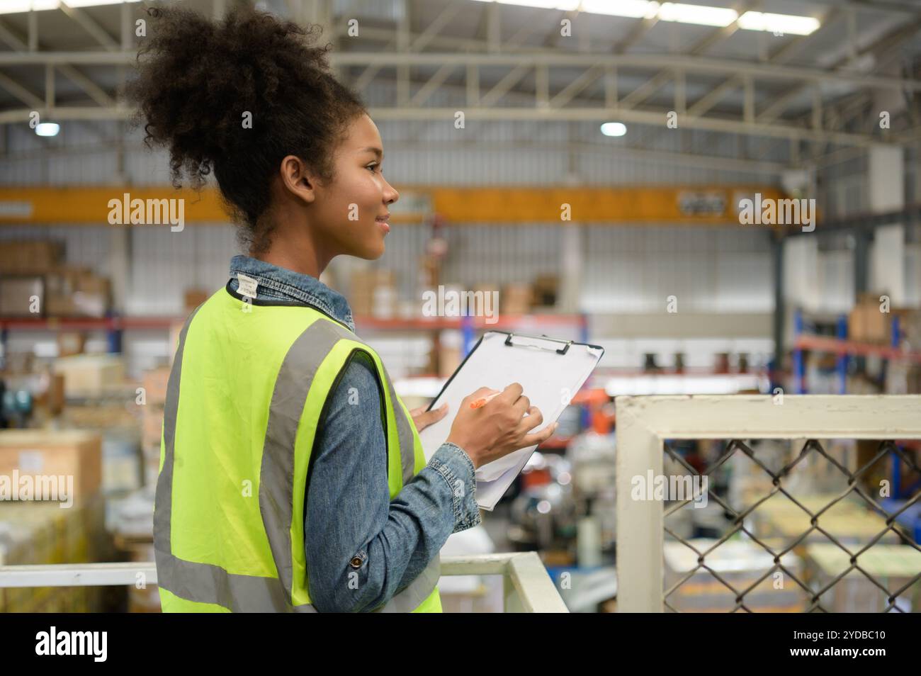 Female warehouse worker Counting items in an industrial warehouse on ...