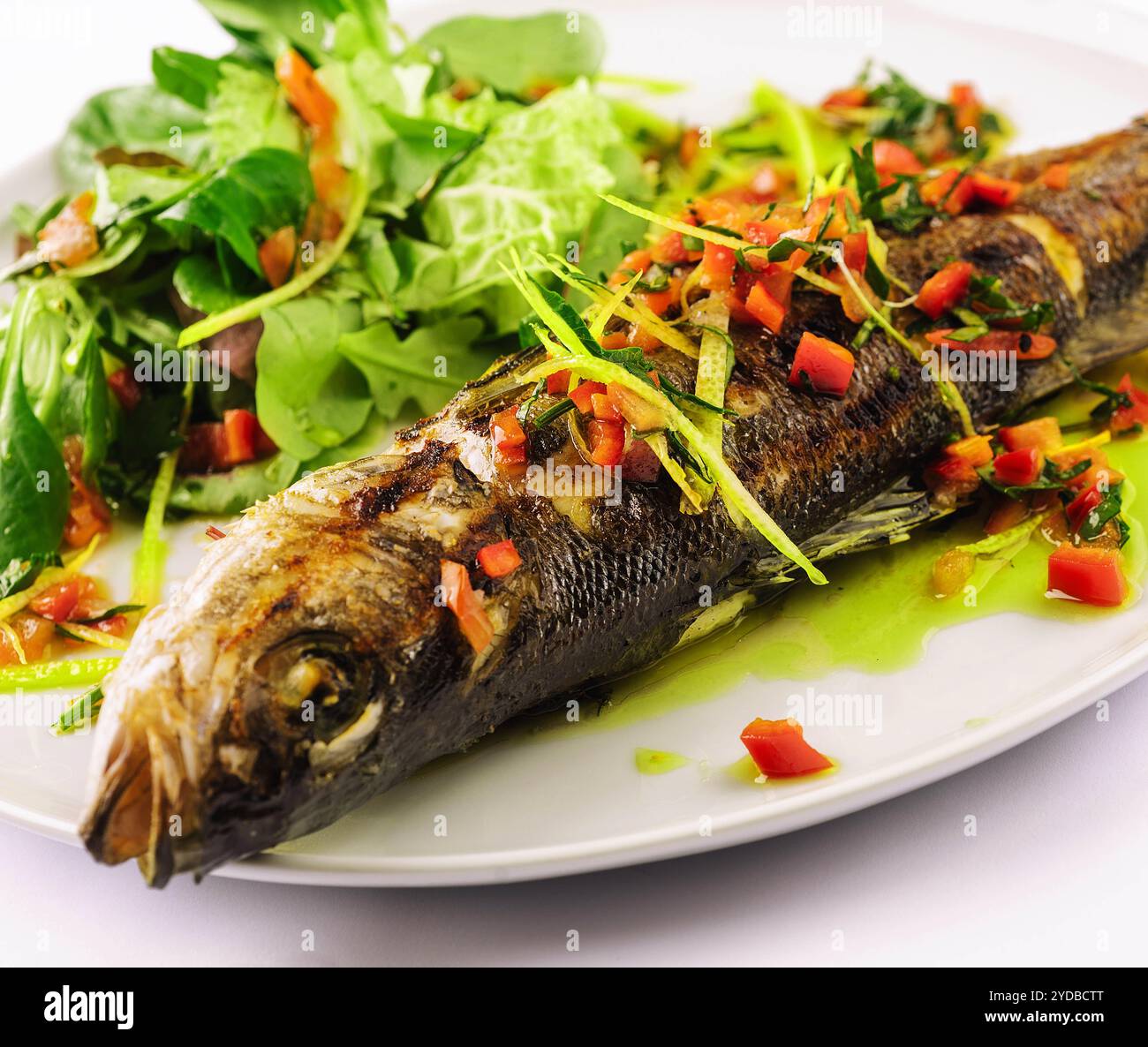 Grilled fish with vegetables on white plate Stock Photo - Alamy